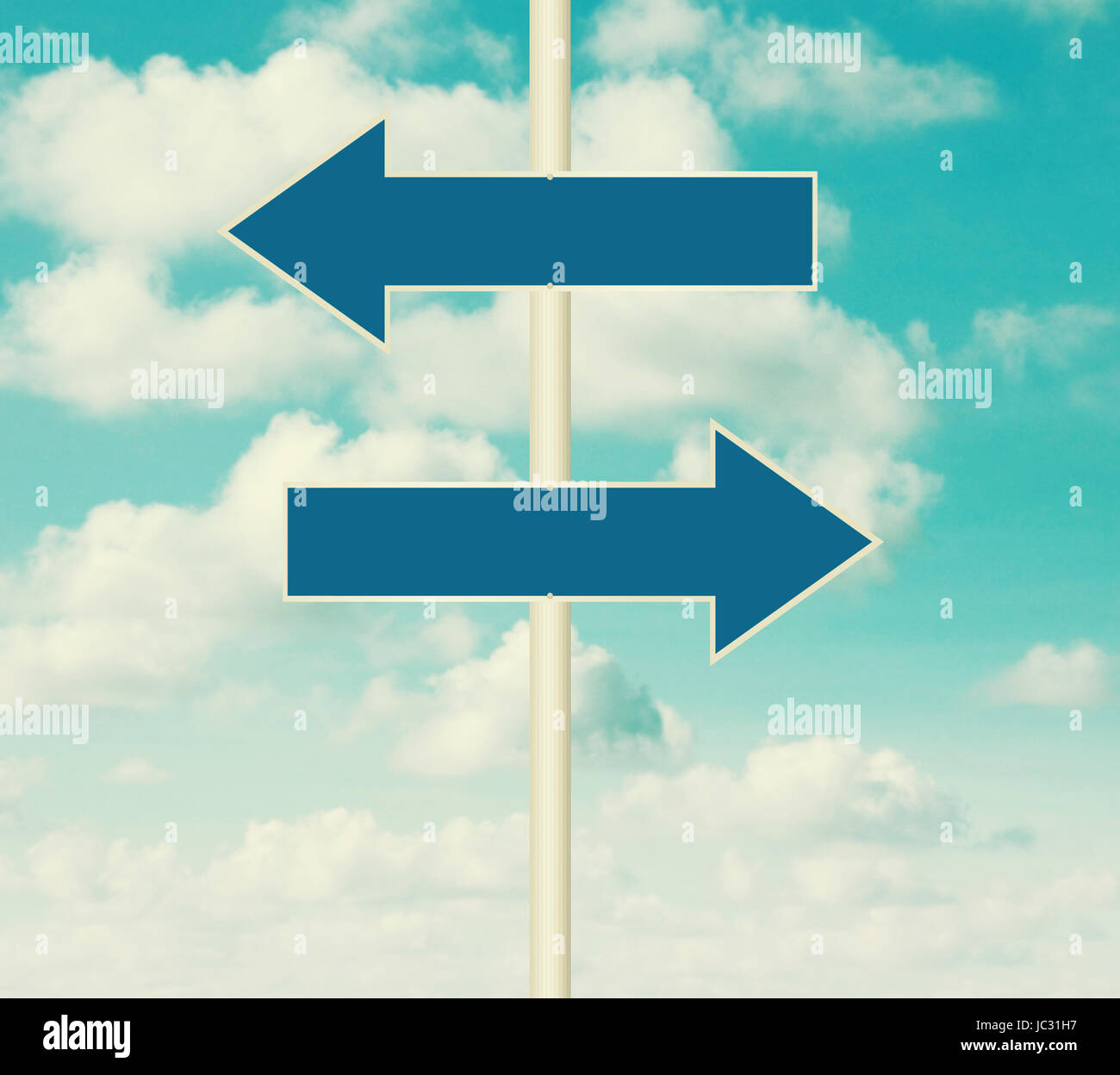 Two blank road signs pointing in opposite directions, blue sky ...