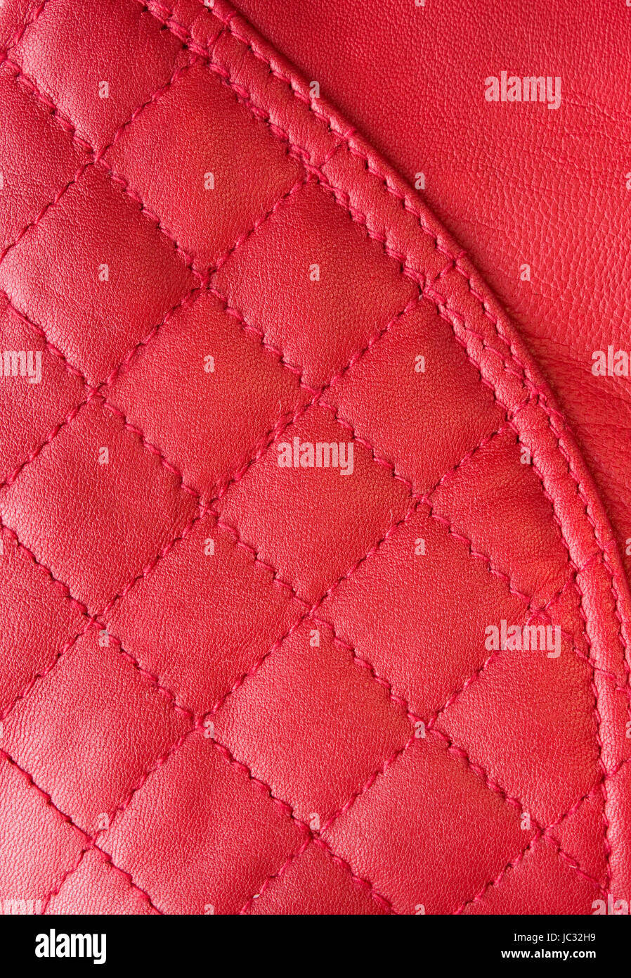Red leather background with rhombus, seams and smooth surface in corner ...