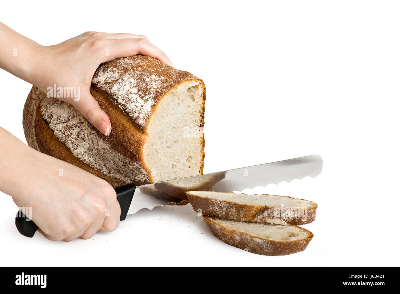 the bread is cut with the knife into slices Stock Photo - Alamy
