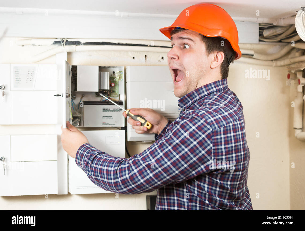 Portrait of handyman being hit by high voltage while repairing ...