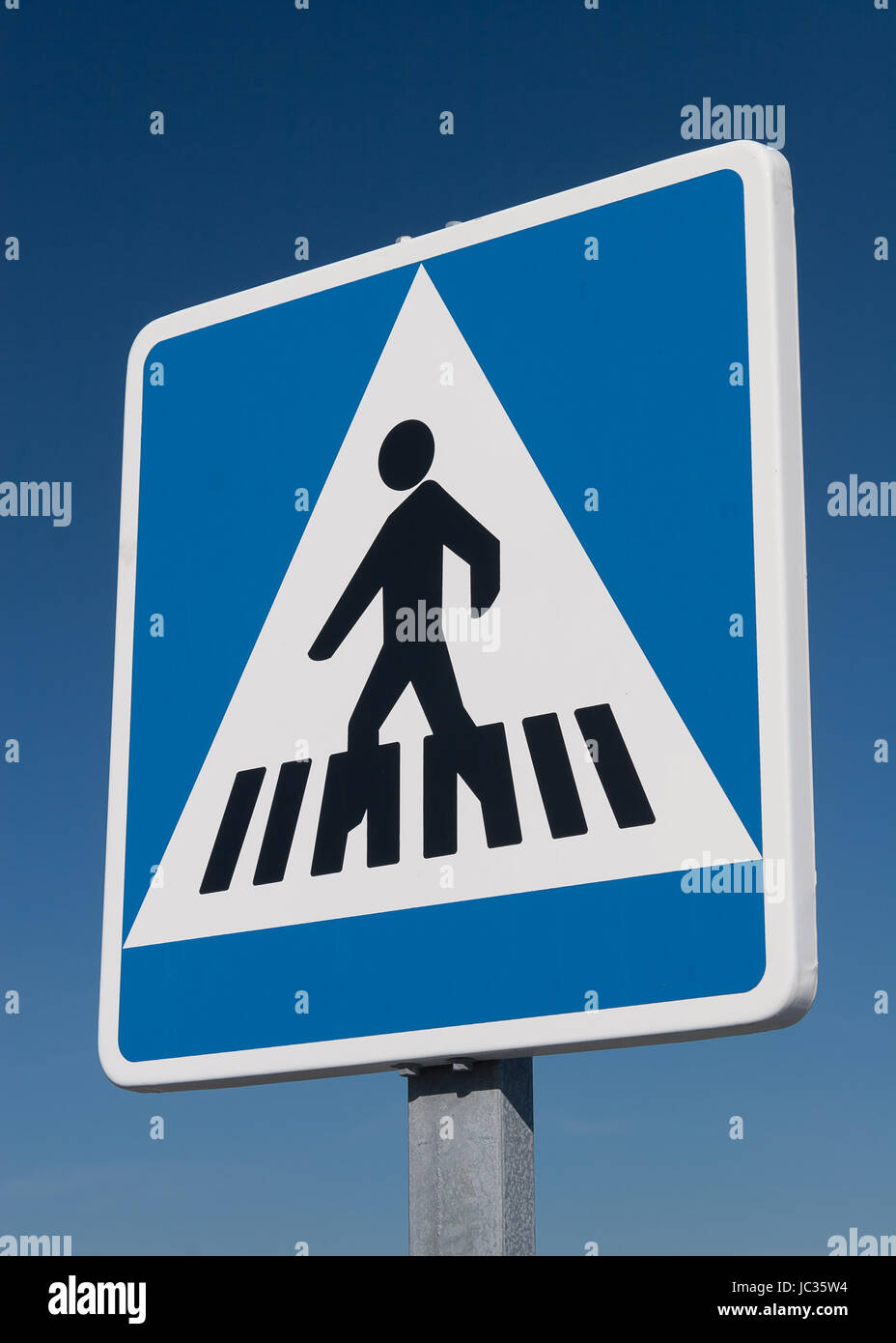 Pedestrian blue road sign against blue sky Stock Photo - Alamy
