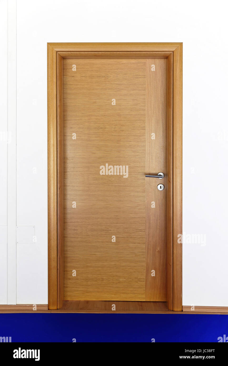 Wooden door at white wall in home Stock Photo - Alamy