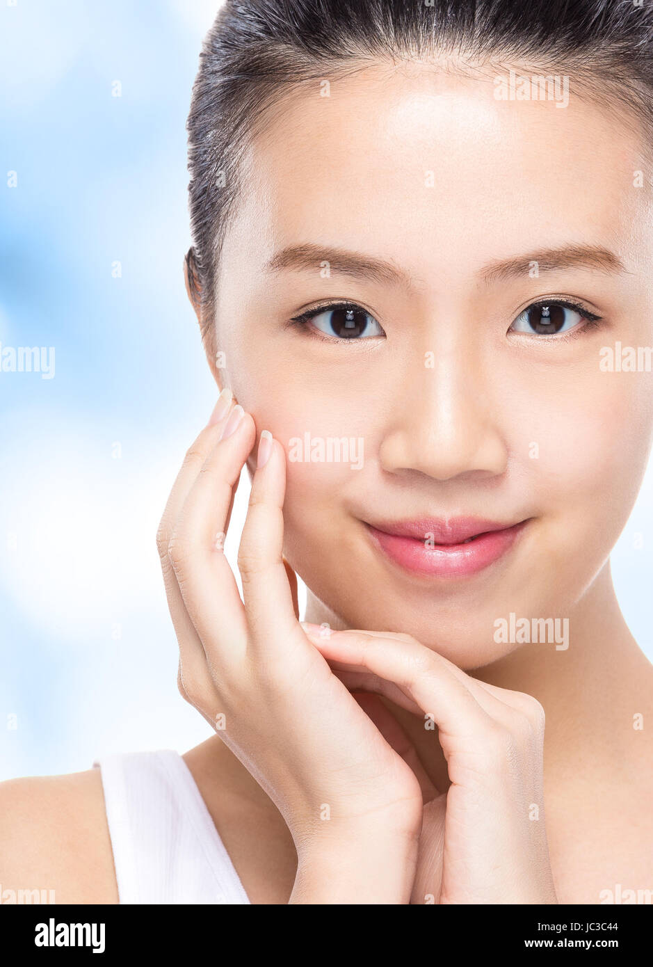Skin care woman with blue background Stock Photo - Alamy