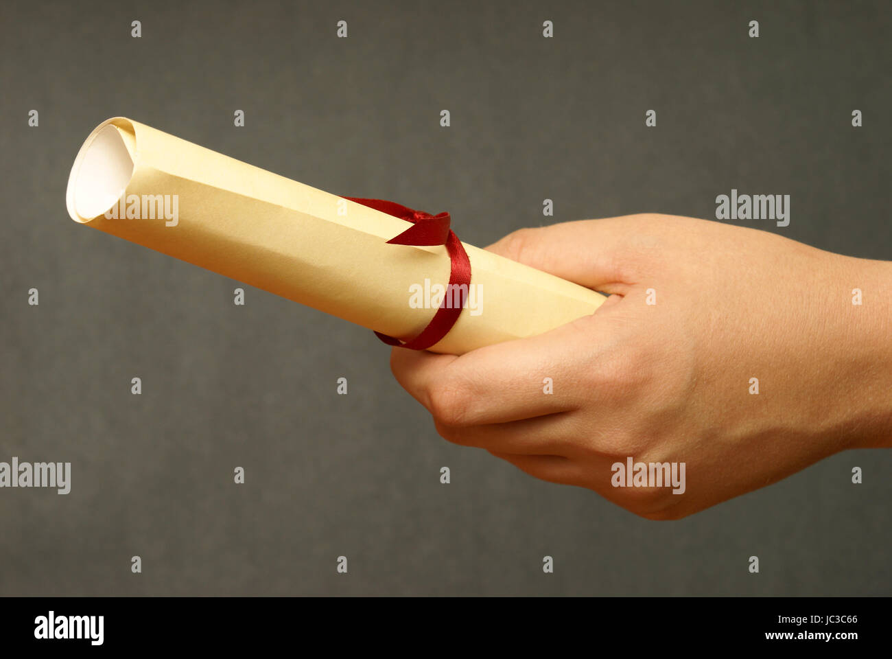 A proud student accepts a diploma during a grad ceremony Stock Photo ...