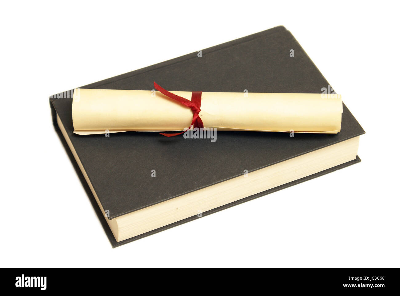 A diploma sits on a textbook for education themes Stock Photo - Alamy