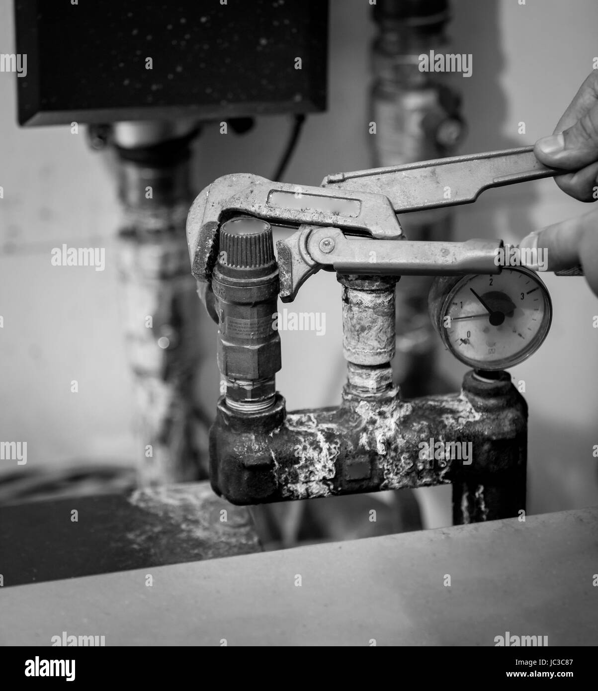Closeup black and white shot of man using pliers while repairing ...