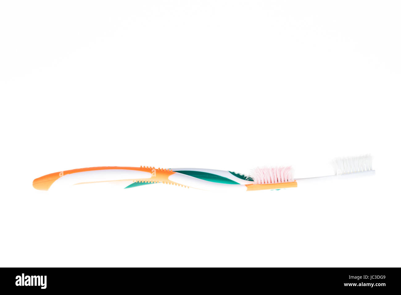Two Color worn toothbrush on white background Stock Photo - Alamy