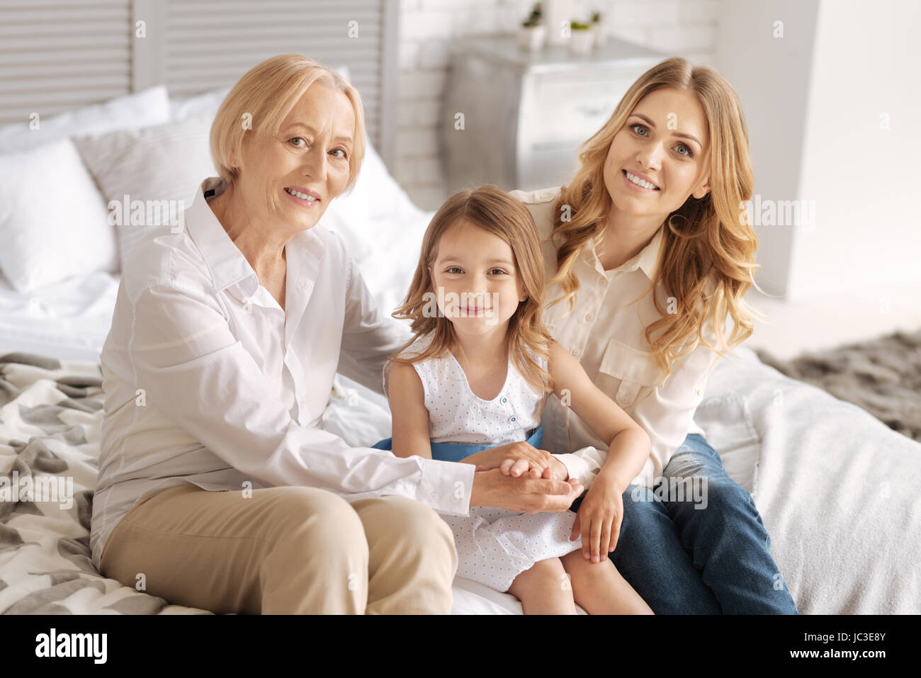 Pleasant extended family bonding on the bed Stock Photo - Alamy