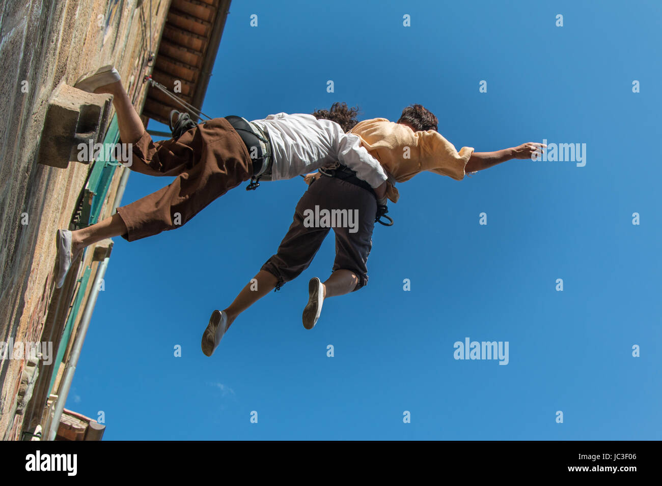 Two Acrobats Doing Artistic Movements on Antique Building Facade Stock ...