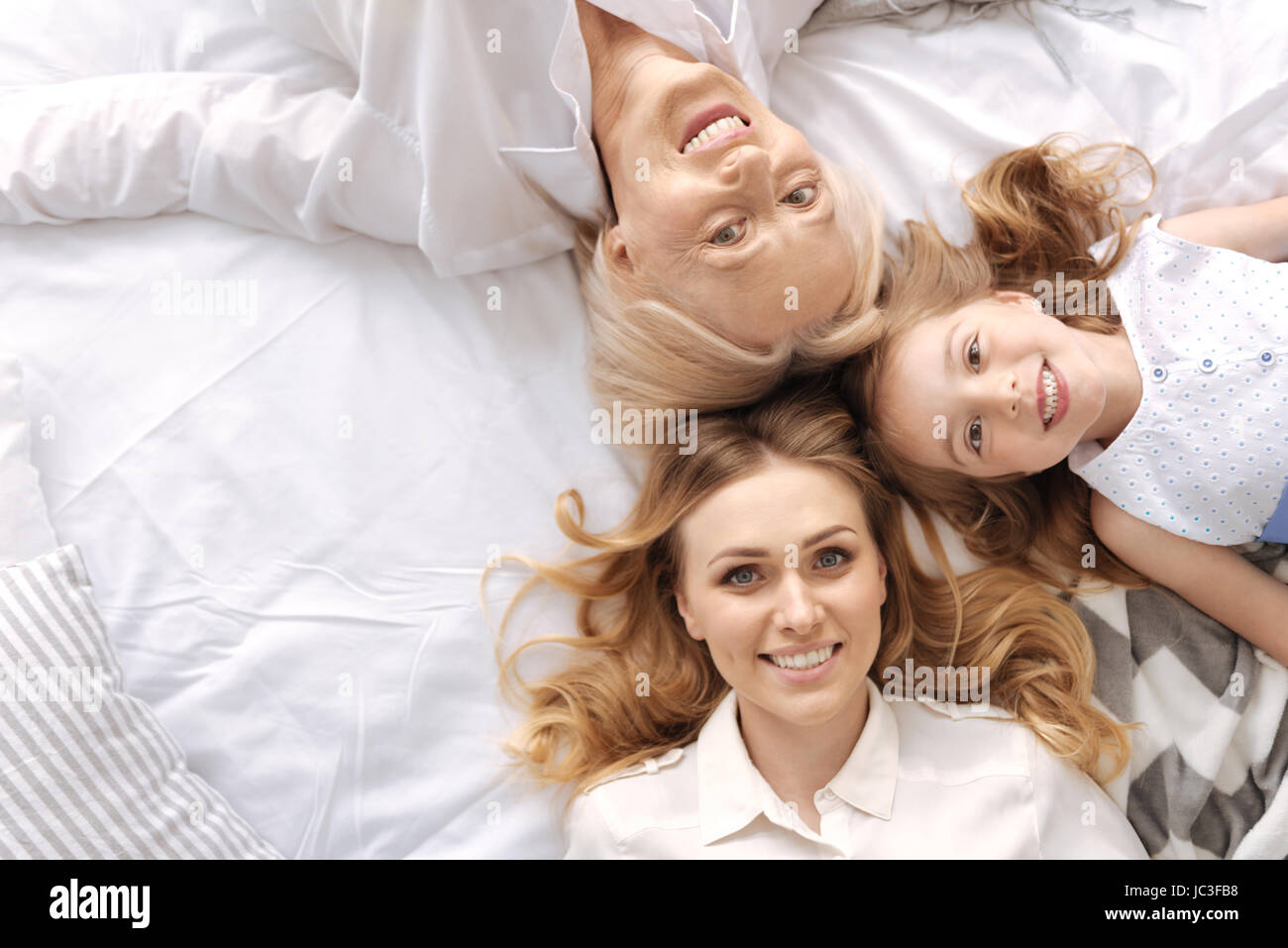 Three pretty females forming a triangle with their heads Stock Photo ...