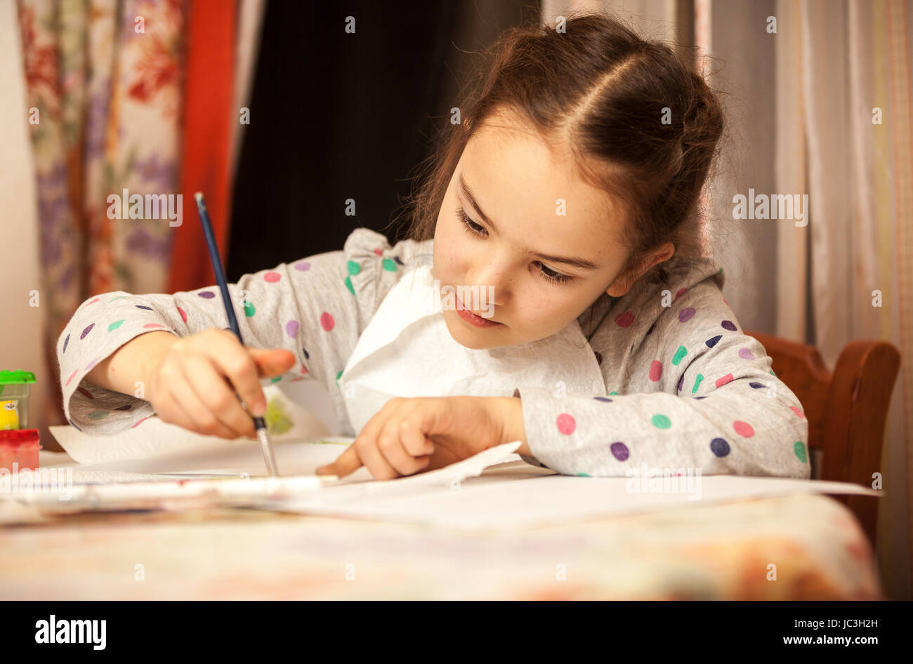 Closeup portrait of little girl drawing on canvas Stock Photo - Alamy