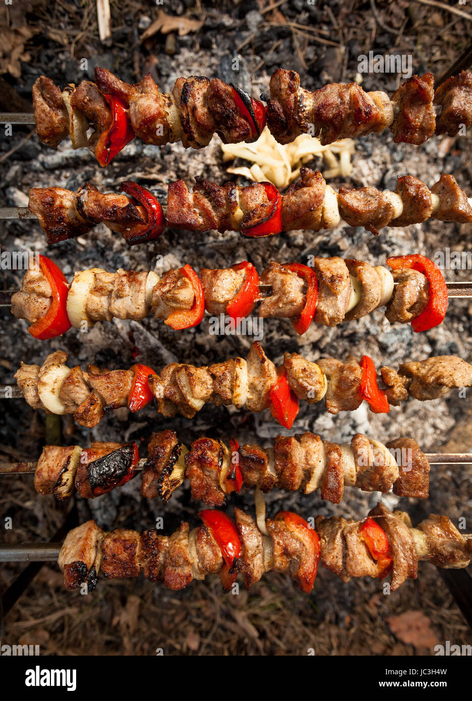 Wide angle photo of kebab being roasted on fire Stock Photo - Alamy