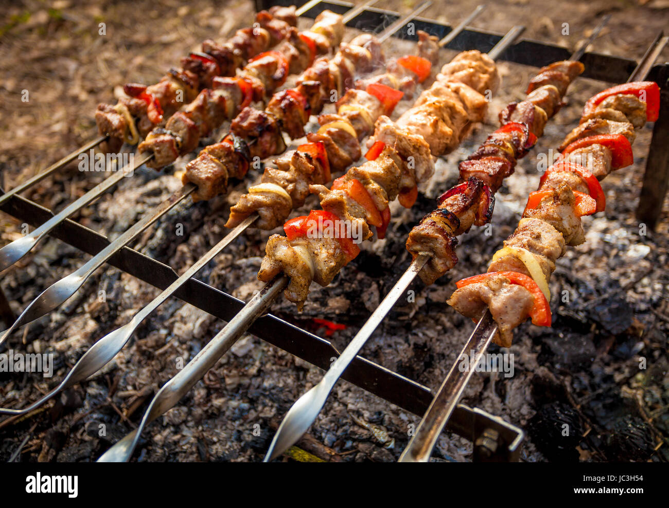 Meat roasted on fire at picnic Stock Photo - Alamy