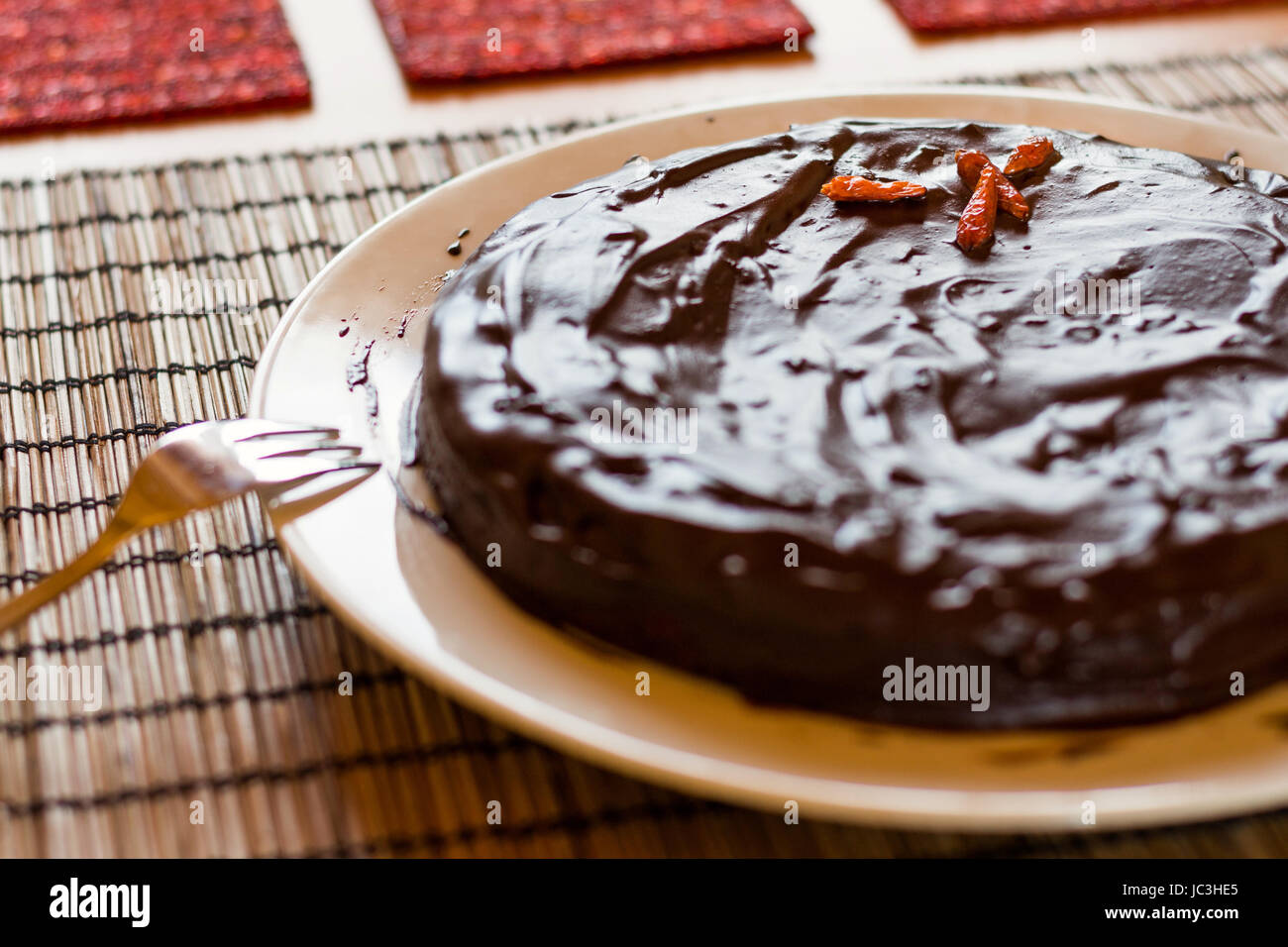 Whole Spicy Chocolate Cake with Chilli Peppers Stock Photo - Alamy