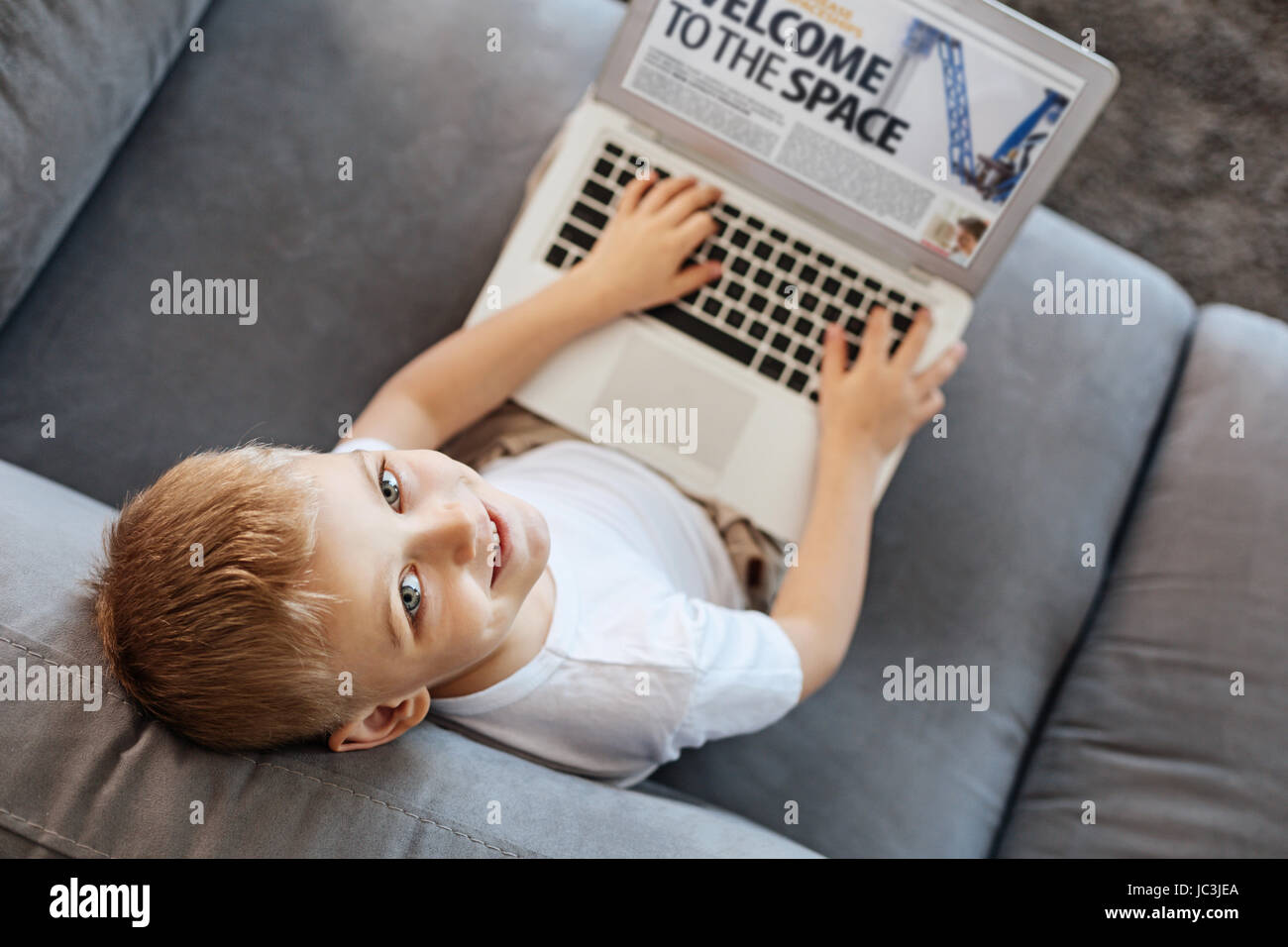 Charming nice boy searching for interesting information online Stock ...