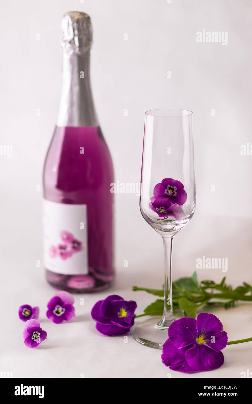 champagne bottle with glass and violet Stock Photo - Alamy