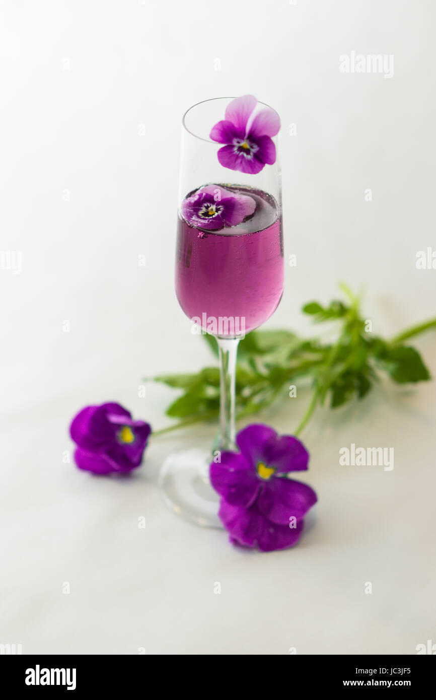 violet prosecco with floating flower Stock Photo - Alamy