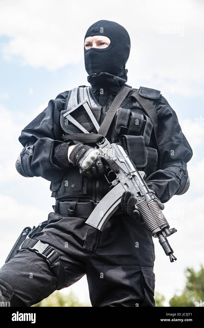 Spec ops soldier in black uniform and face mask with his rifle Stock ...
