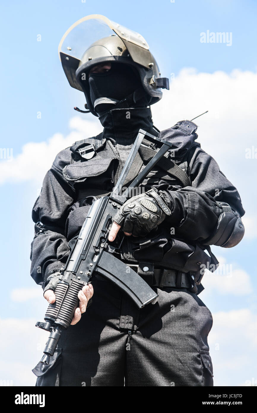 Spec ops soldier in black uniform and face mask with his rifle Stock ...