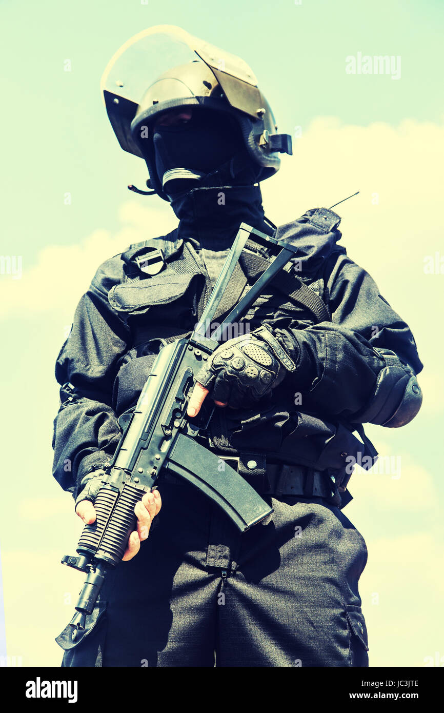 Spec ops soldier in black uniform and face mask with his rifle Stock ...