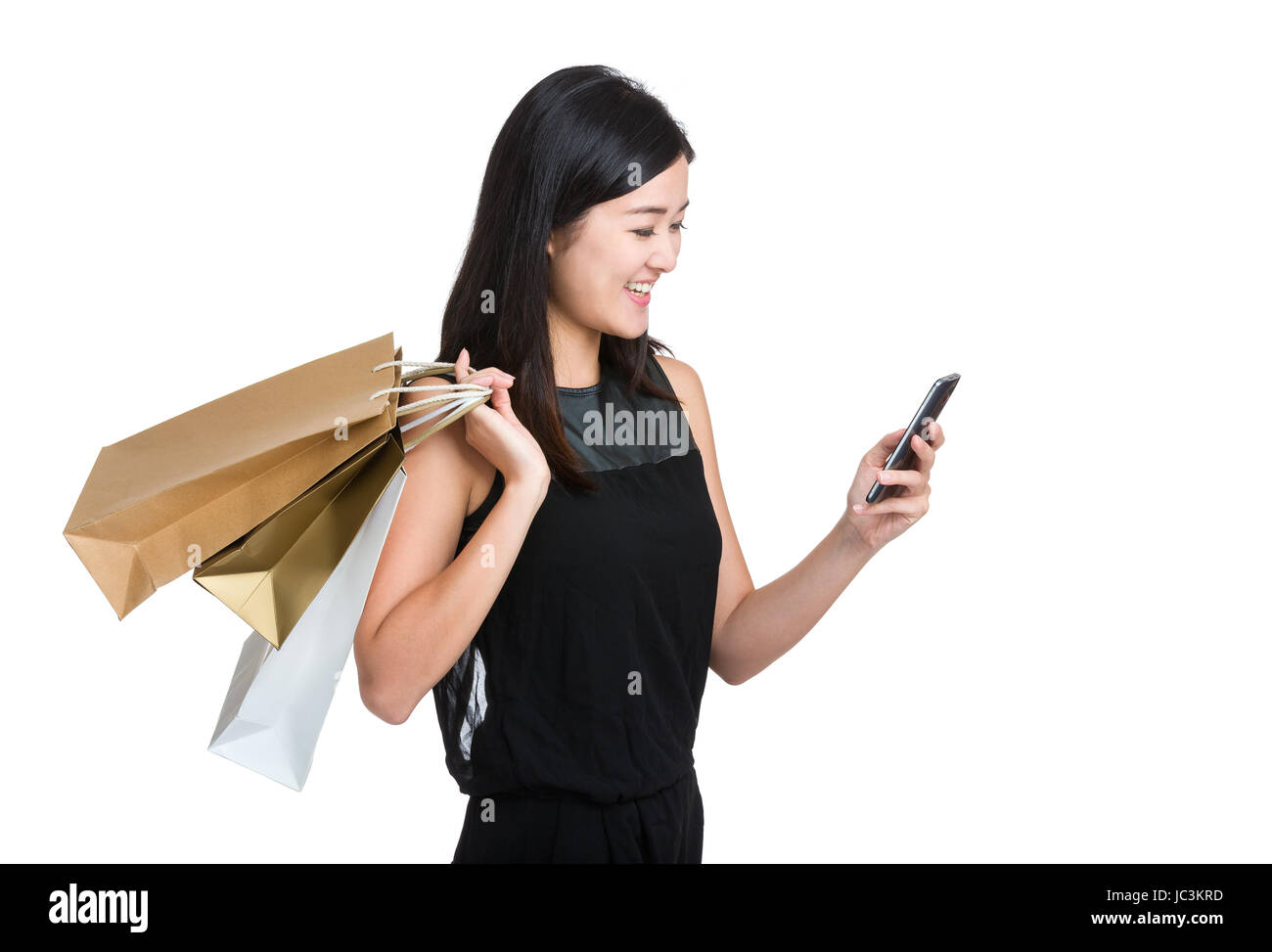 Asian young woman use mobile phone with shopping bag Stock Photo - Alamy