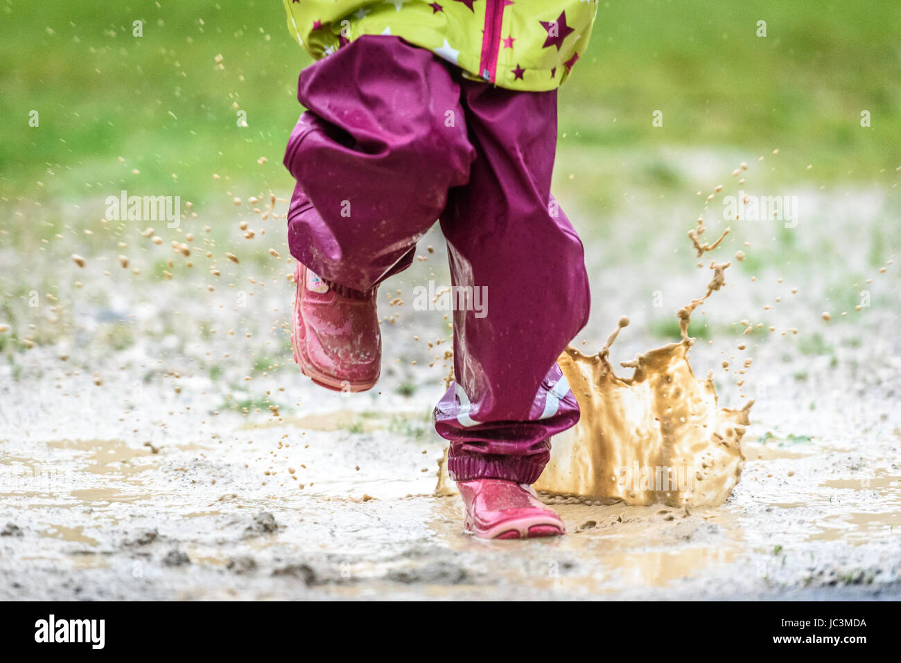 Child Splash Puddles Boots Stock Photos & Child Splash Puddles Boots ...
