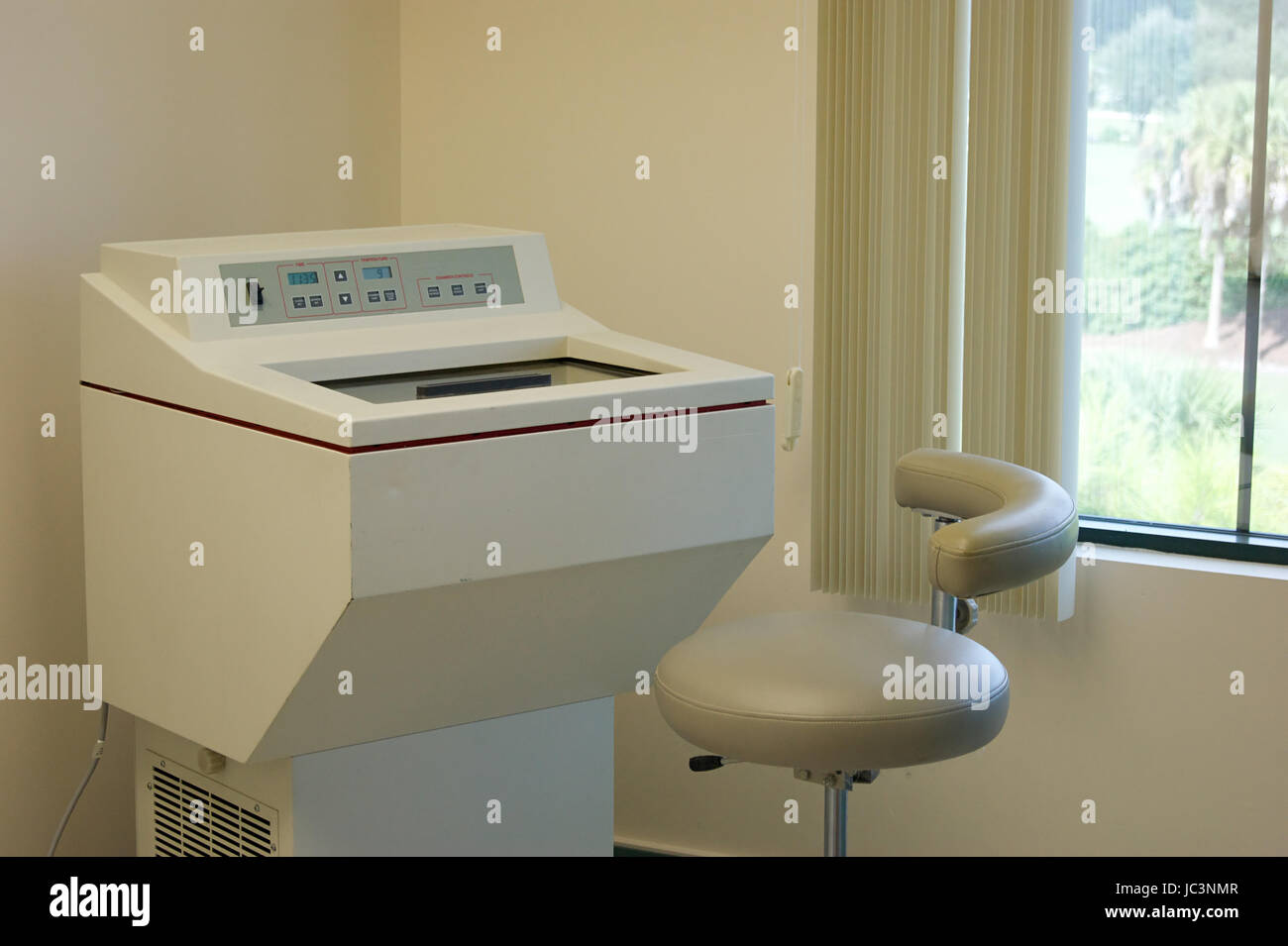 A blood testing machine and leather stool in doctor's office Stock ...