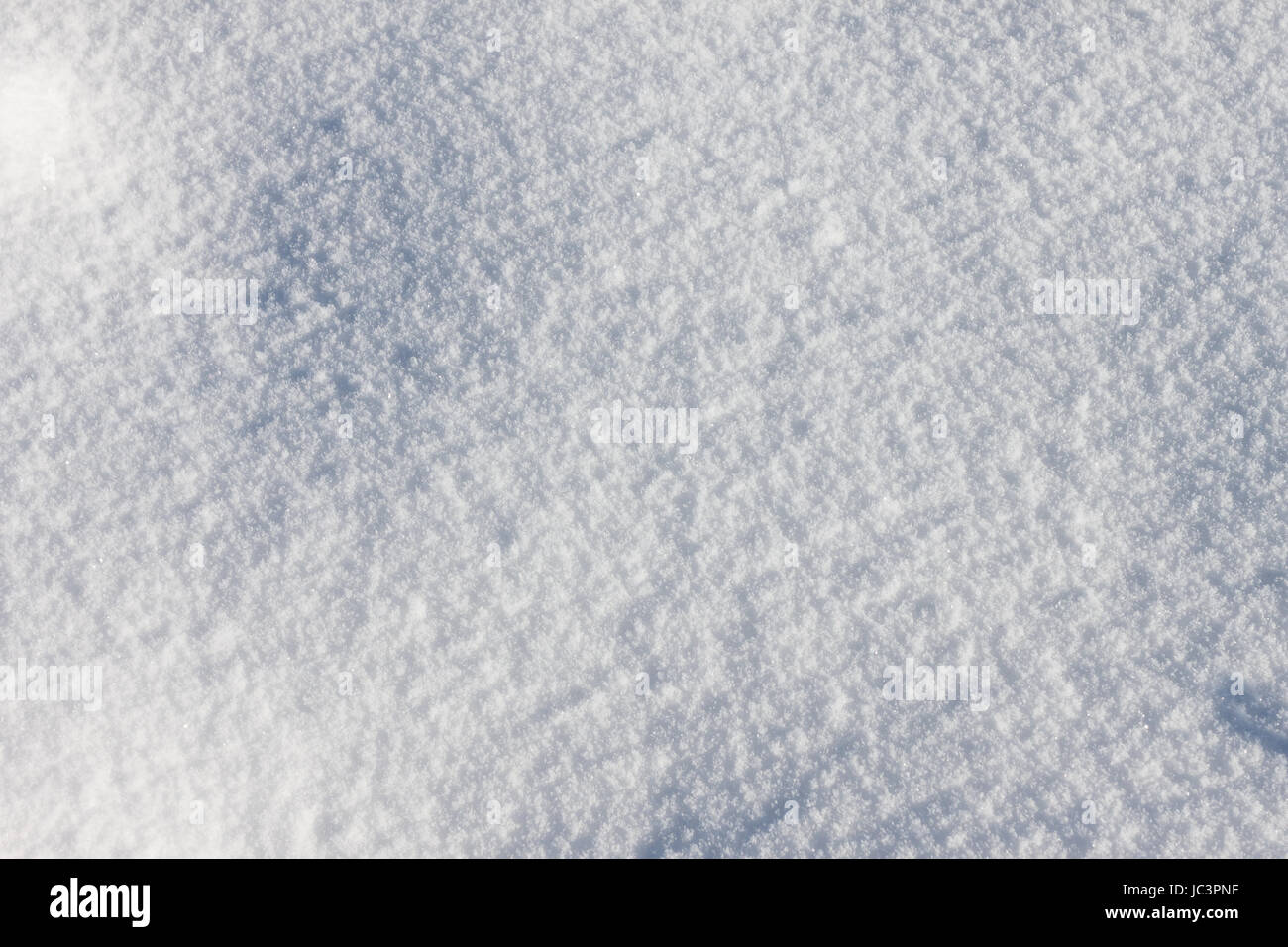 White frost snow toned in blue background Stock Photo - Alamy