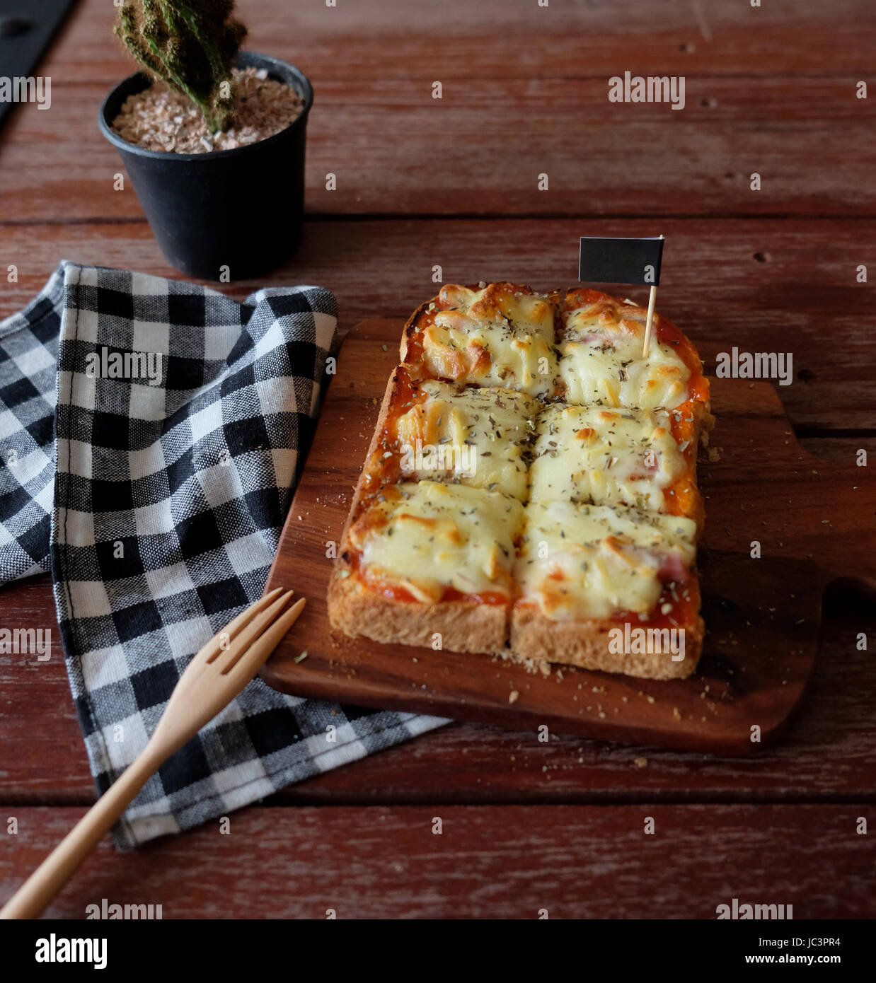 Pizza toasted bread with tomato sauce and ham cheese selective focus ...
