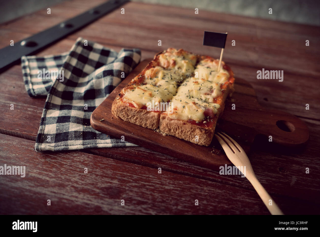 Pizza toasted bread with tomato sauce and ham cheese selective focus ...