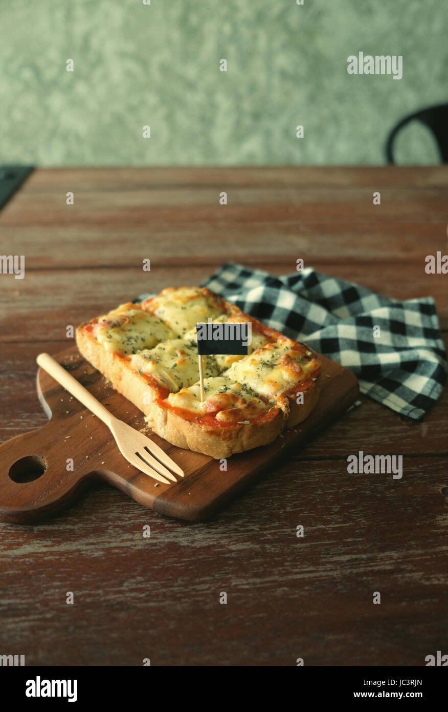 Pizza toasted bread with tomato sauce and ham cheese selective focus ...