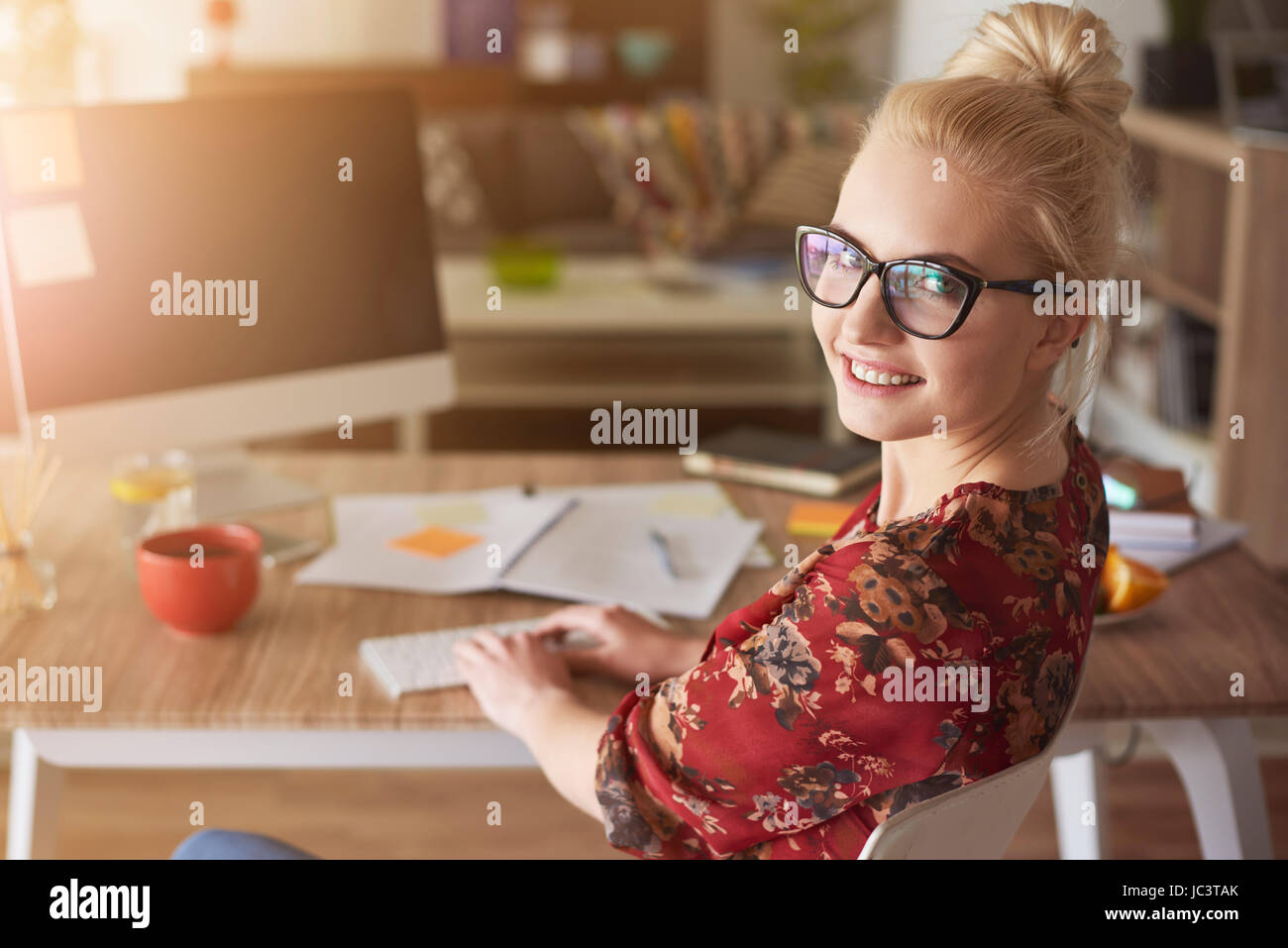 Busy young woman at work Stock Photo - Alamy