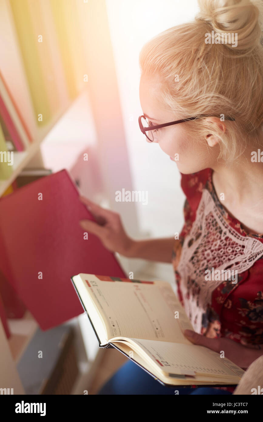 Woman and shelf and high hi-res stock photography and images - Alamy