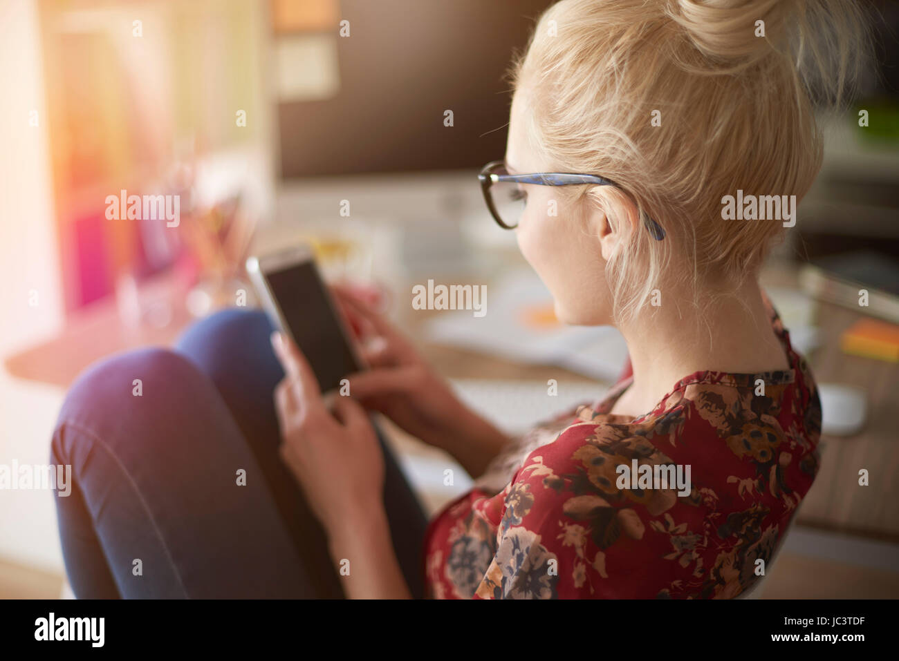 Rear view of woman with mobile phone Stock Photo - Alamy