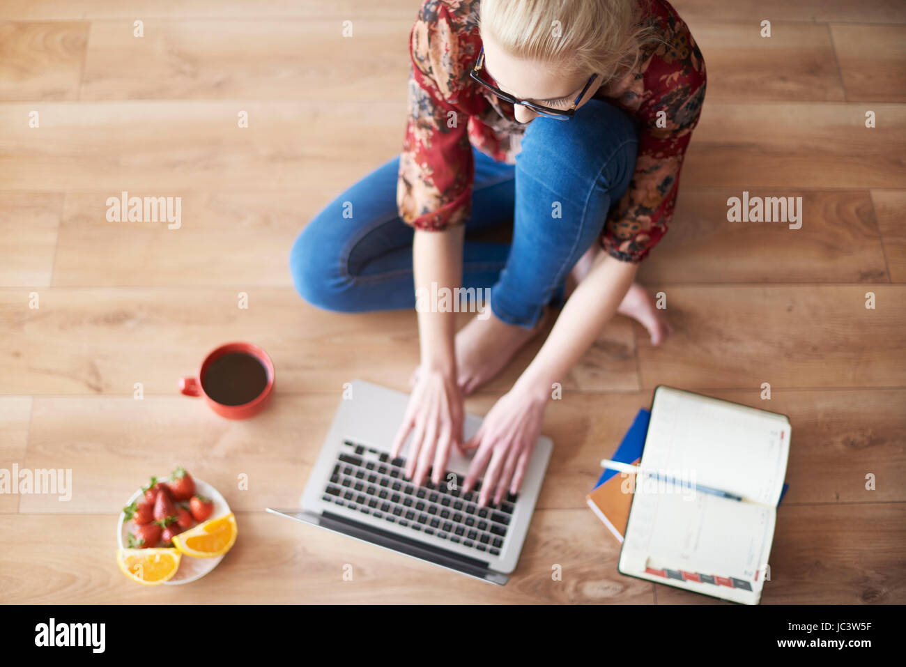 Working with laptop on the floor Stock Photo - Alamy