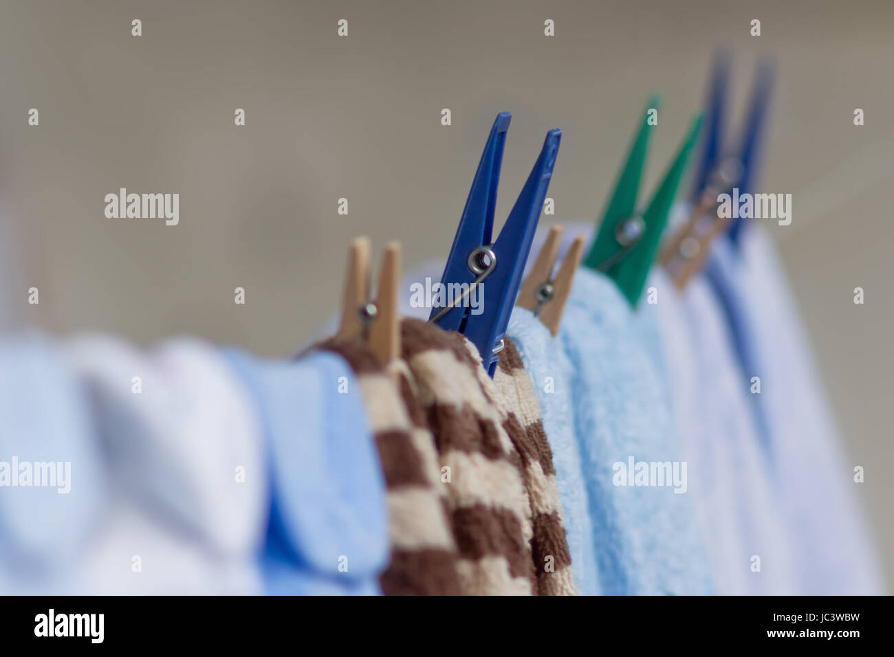 Photo of clothespins holding clothes on the clothesline with blue one ...