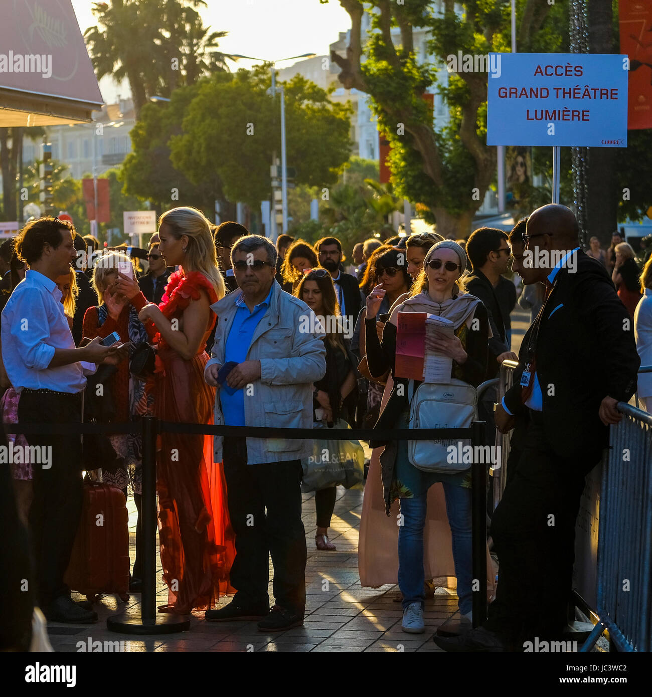 People Queue and wait to enter a screening at Cannes Film Festival. The ...