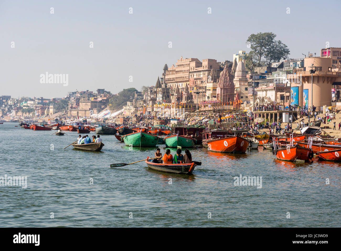 Rowing boats are driving on the holy river Ganges at Dashashwamedh Ghat ...