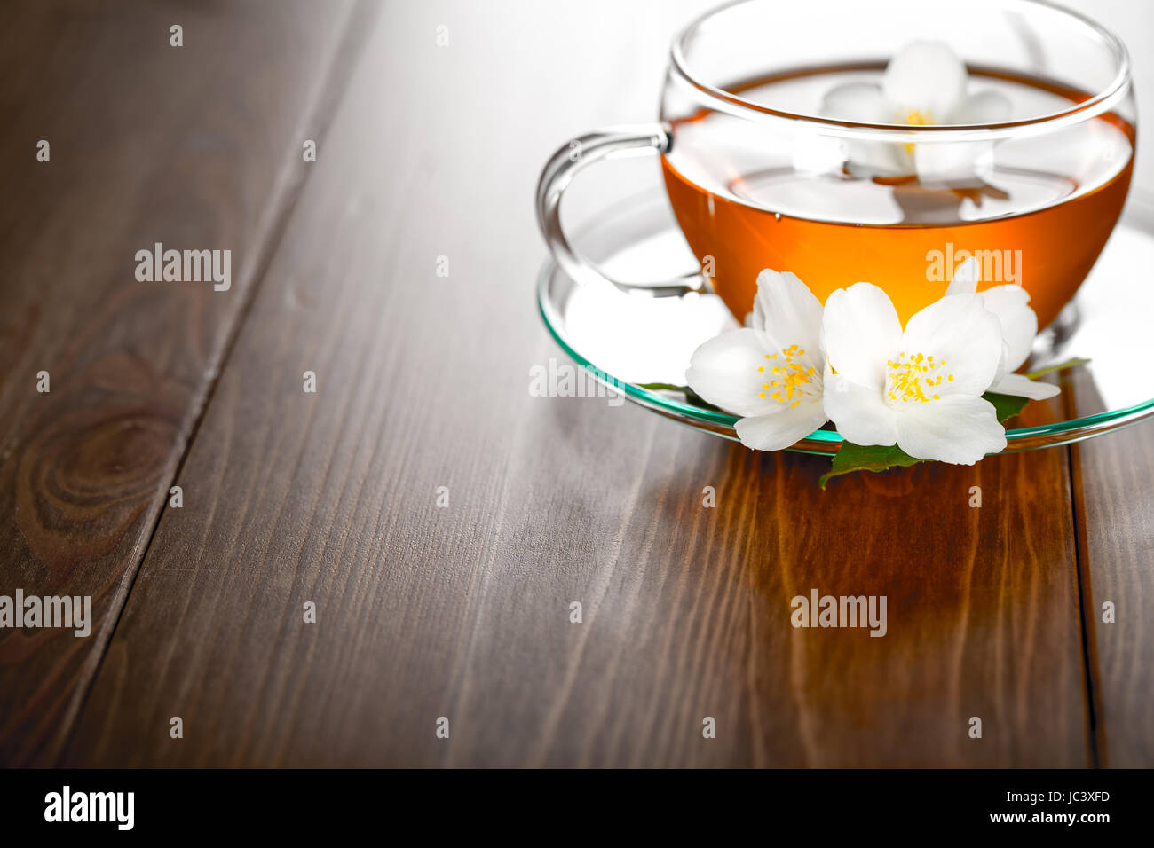 Jasmine tea with jasmine herb flower on wooden background. Copy space ...