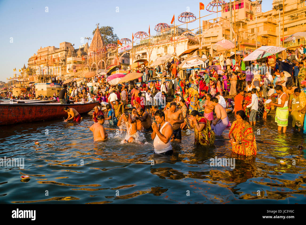 Pilgrims are taking bath in the holy river Ganges at Dashashwamedh Ghat ...