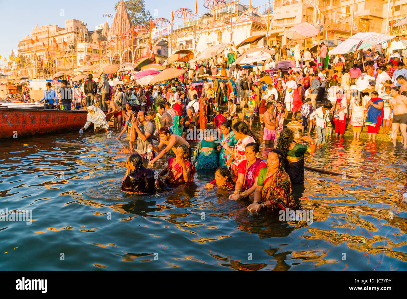 Pilgrims are taking bath in the holy river Ganges at Dashashwamedh Ghat ...