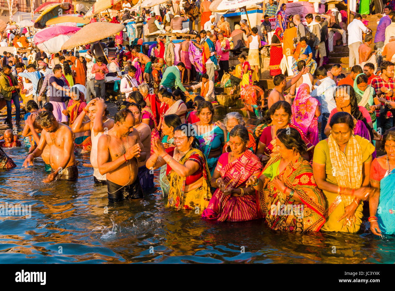 Pilgrims are taking bath in the holy river Ganges at Dashashwamedh Ghat ...