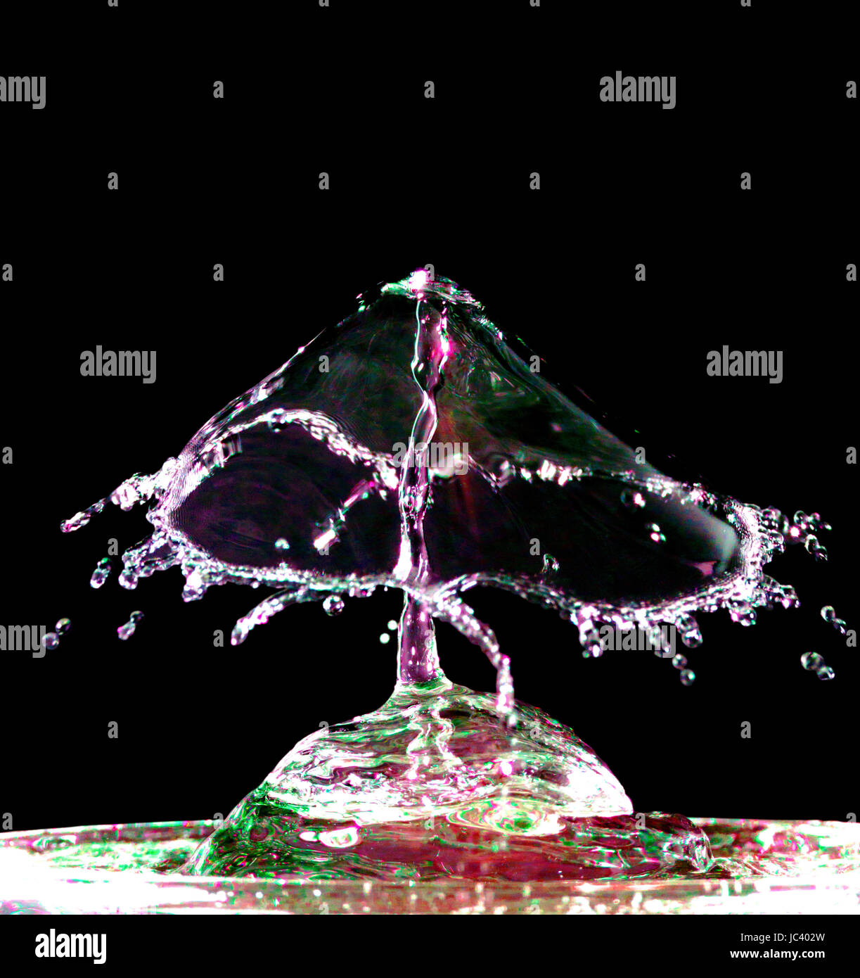 Colorful liquid splash on black background closeup Stock Photo - Alamy