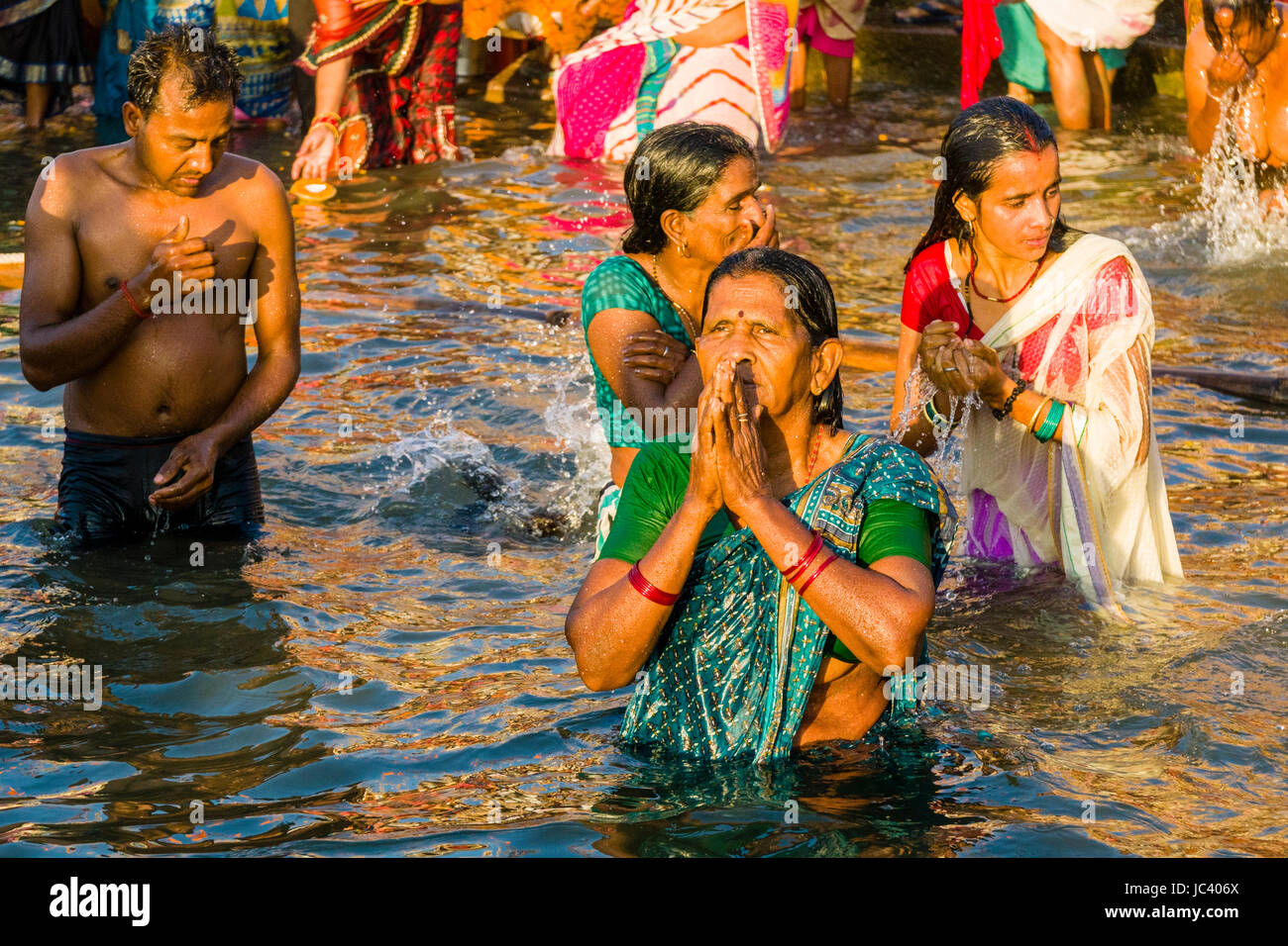 Pilgrims are taking bath in the holy river Ganges at Dashashwamedh Ghat ...