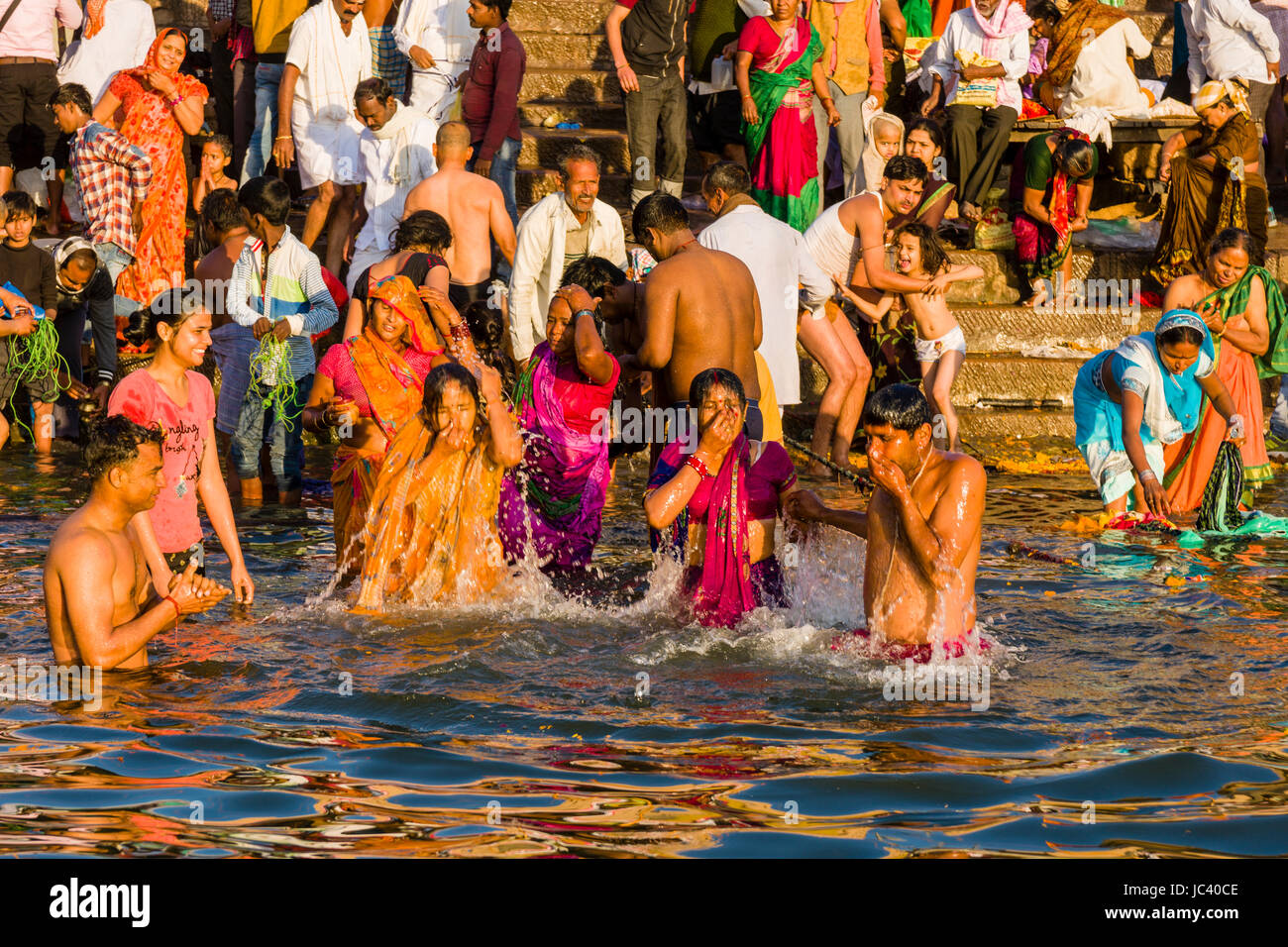 Pilgrims are taking bath in the holy river Ganges at Dashashwamedh Ghat ...