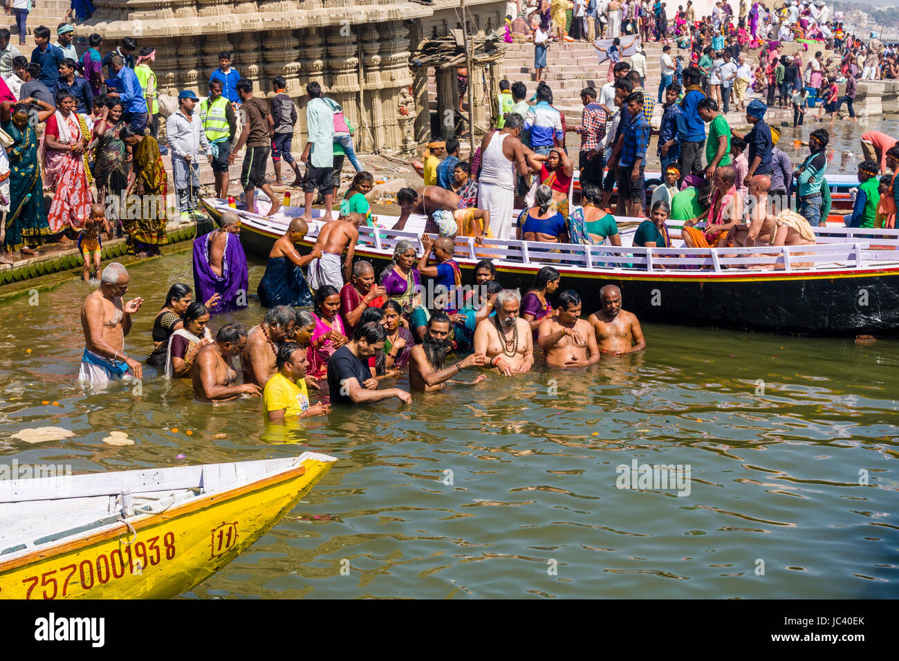 Pilgrims are taking bath in the holy river Ganges at Dashashwamedh Ghat ...
