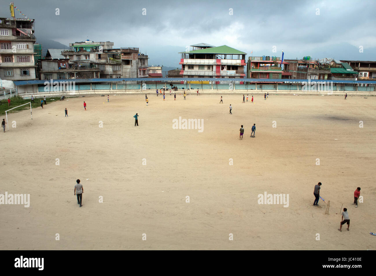 Locals playing cricket and football in the Kalimpong Mela Ground a ...