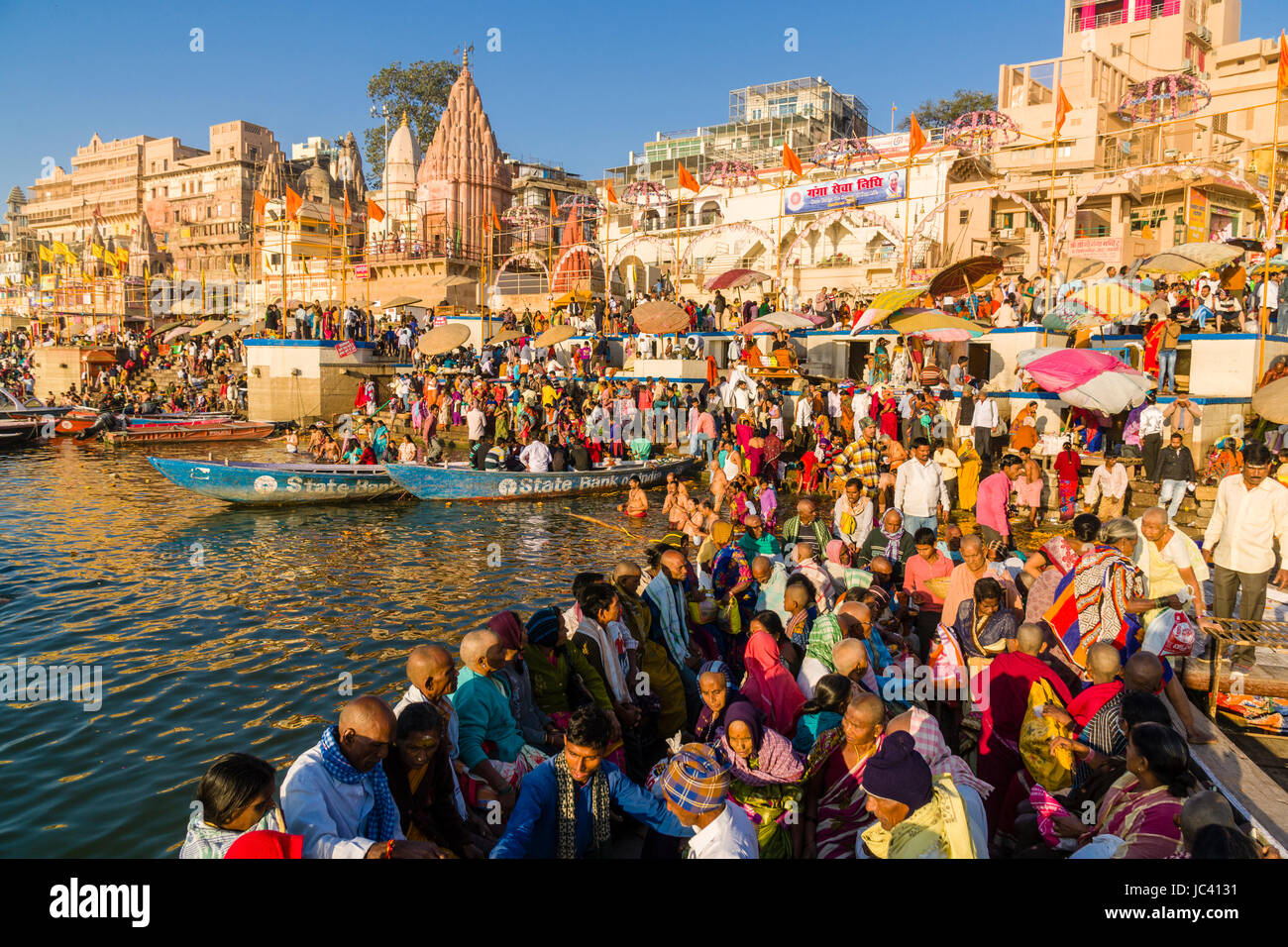 Pilgrims are taking a boat ride on the holy river Ganges at ...