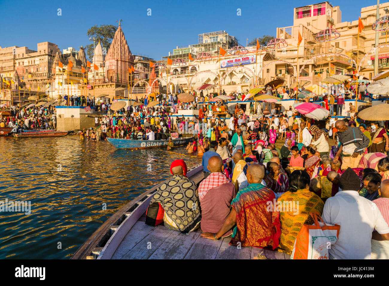 Pilgrims are taking a boat ride on the holy river Ganges at ...