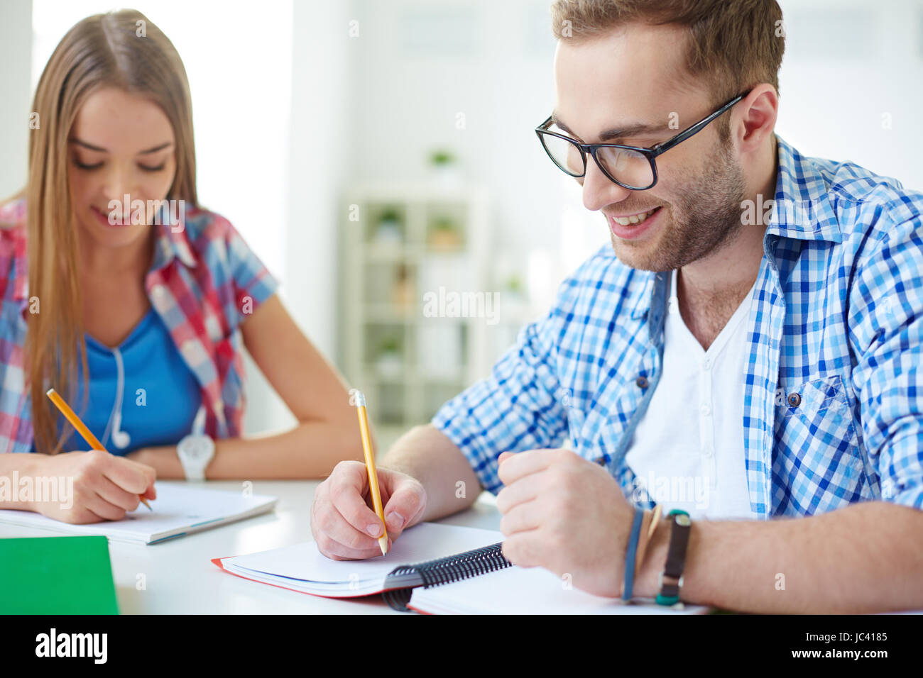 Man doing classwork at university Stock Photo - Alamy